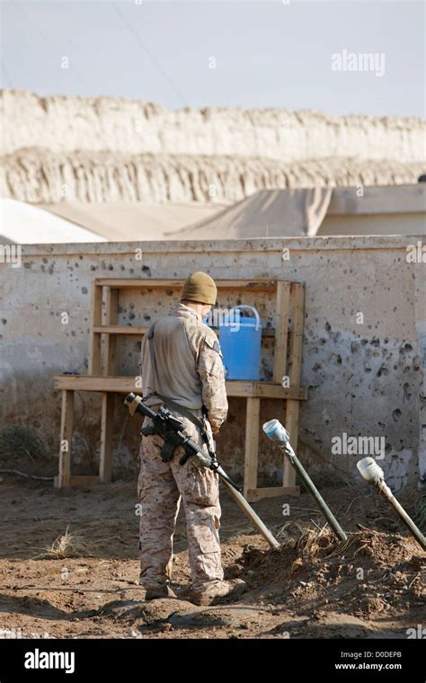 A Us Marine Urinates Into A Piss Tube At A Combat Outpost In