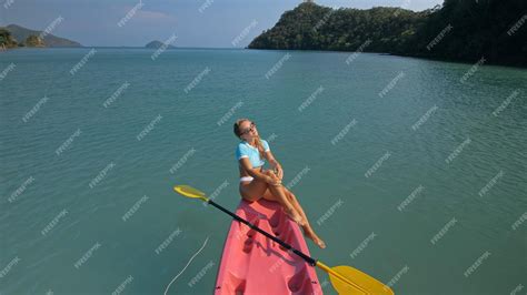 Premium Photo Sexy Young Woman In Blue Swimsuit Swings Feet In Water