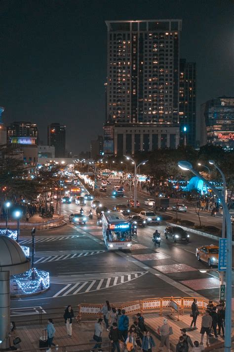 야간에 고층 건물 근처의 도로에있는 자동차 사진 Unsplash의 무료 길 이미지