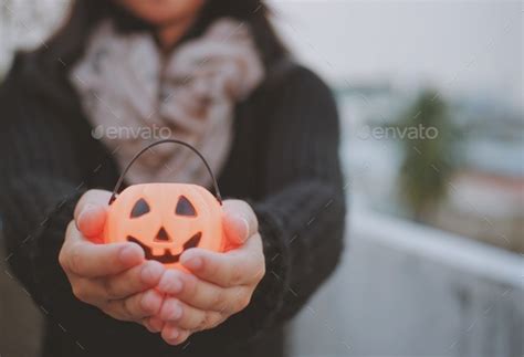 Girl Holding Jack O Lantern For Trick Or Treat In Halloween Concept