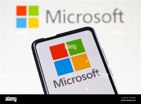 Microsoft Logo Of The Software Company On A Cell Phone And Computer Screen Stock Photo Alamy