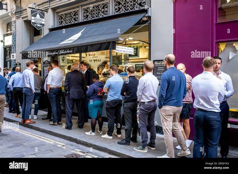 City Of London Workers Queue For A Takeaway Lunch At The Porterford Butchers In The City Of