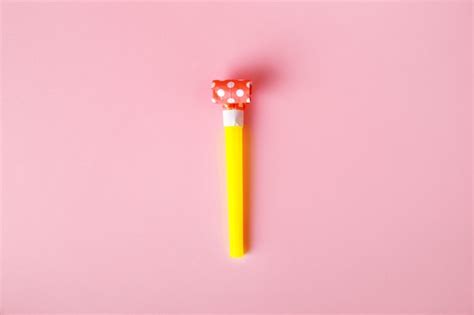 Premium Photo Party Whistle Or Blower Over Pink Background Party And