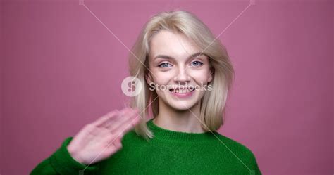 Caucasian Woman Waving Hello On A Pink Background Moment Stock Image