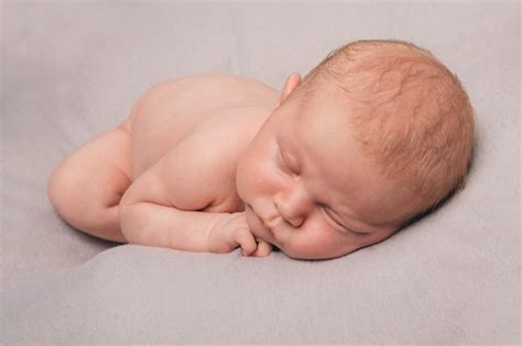 Premium Photo Naked Newborn Baby Sleeping Curled Up In A Ball