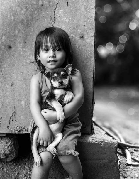 Premium Photo Portrait Of Cute Girl With Cat Sitting Outdoors