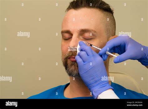 Cosmetician Making Botulinum Toxin Injections To Male Patient Beauty
