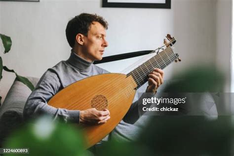 A Man Playing A Lute Photos And Premium High Res Pictures Getty Images