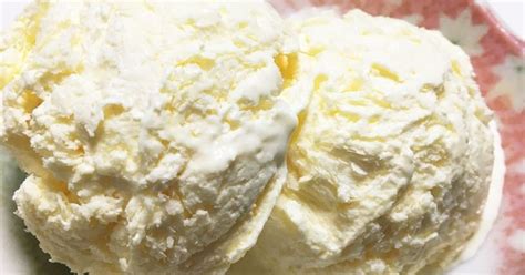 Two Scoops Of Ice Cream Sitting On Top Of A Pink And White Flowered Plate