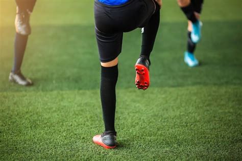 Premium Photo Low Section Of People Running On Soccer Field
