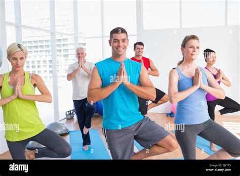 People Practicing Tree Pose In Fitness Studio Stock Photo Alamy