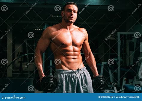Training In Gym With Dumbbells Sportsman With Naked Torso Sporty