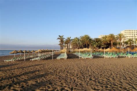 Beach Lounge Chair And Beach Umbrella At Lonely Sandy Beach Costa Del