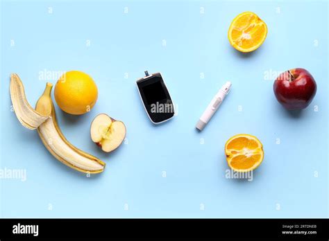 Digital Glucometer Lancet And Healthy Fruits On Blue Background
