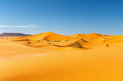 Photo Of A Vast Desert With Sand Dunes Under A Clear Blue Sky Stock