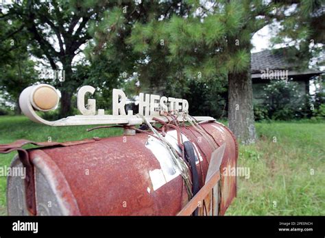 String And Wire Hold The Name Plate On The Mailbox In Front Of The Home