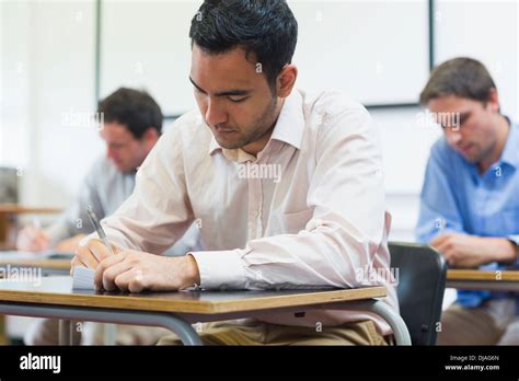 Mature Babes Taking Notes In Classroom Stock Photo Alamy