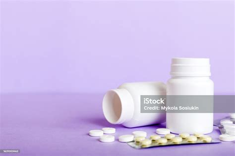 Hiv 감염 치료를위한 약 알약과 캡슐과 테이블 위의 전투 복사 공간이있는 컬러 배경의 다양한 다채로운 태블릿 0명에 대한 스톡