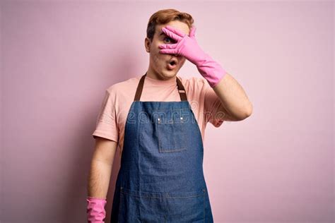 Young Handsome Redhead Cleaner Man Doing Housework Wearing Apron And