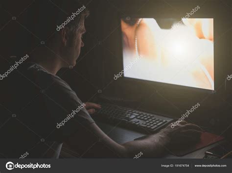 Man Watching Erotic Movie On Computer At Night Stock Photo Mproduction