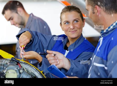 Female Apprentice Mechanic Smiling At Supervisor Stock Photo Alamy