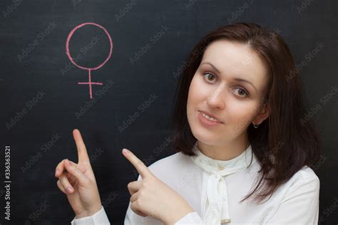 Teacher Girl At The Chalkboard Shows The Gender Symbol Of A Woman Sex