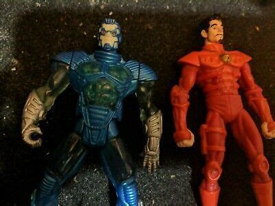 Two Action Figures One In Red And The Other In Blue Are Standing Next To Each Other