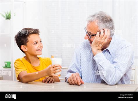 Grandfather And Grandson Are Drinking Milk At Home Healthy Lifestyle Stock Photo Alamy