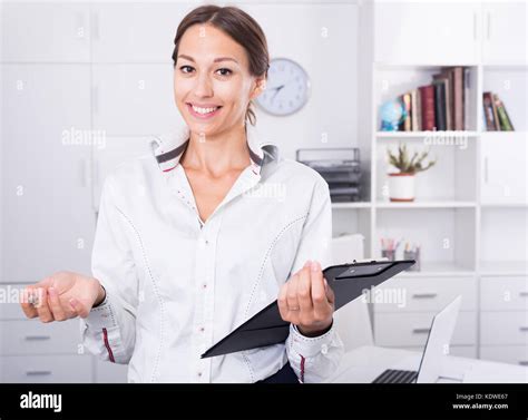 Cheerful Woman Having Clipboard In Hands In Company Office Indoors Stock Photo Alamy