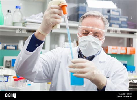 Scientist Filling A Flask In A Chemical Laboratory Stock Photo Alamy