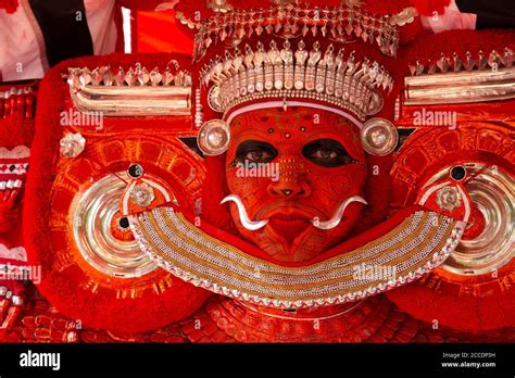 Traditional Theyyam Performer Adorned In Elaborate Costume And Makeup