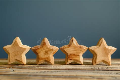 Wooden Stars Arranged In A Row Symbolizing A Satisfaction Rating System Used For Evaluating