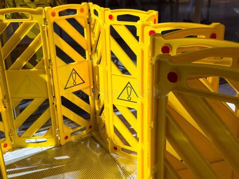 Yellow Caution Barrier With Warning Symbols In Public Area Editorial