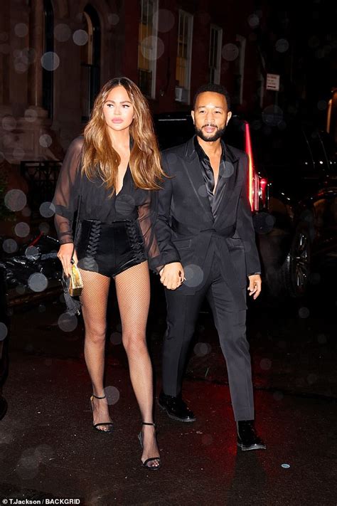 Chrissy Teigen Pairs Tiny Hot Pants With A Sheer Blouse As She And