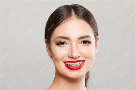 Premium Photo Cheerful Woman With Braces On Teeth Beautiful Model In Braces Smiling On White