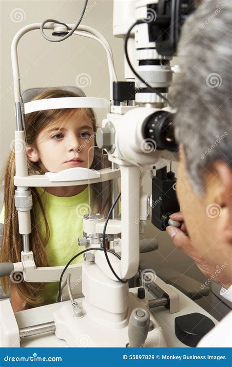 Optician In Surgery Giving Girl Eye Test Stock Image Image Of Care