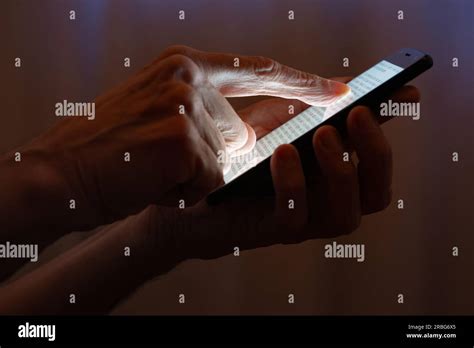 Man Typing With The Finger On The Touch Screen Of A Black Smartphone