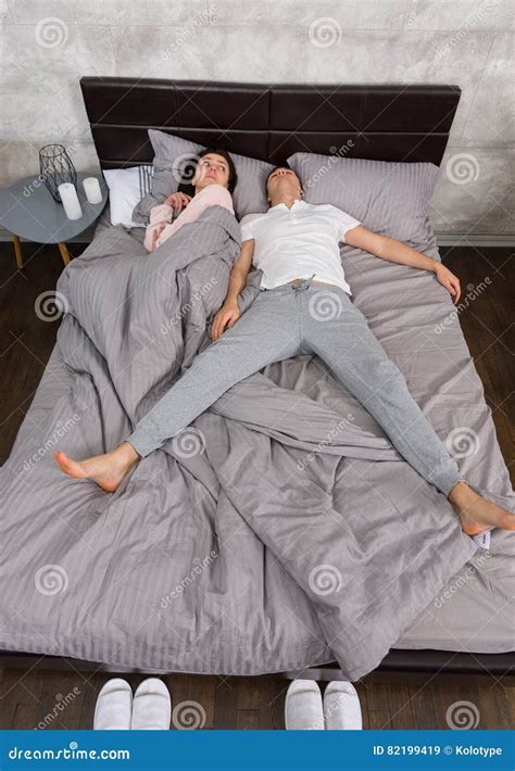 Young Male Sleeping In Free Fall Position With His Wife Occupied Stock