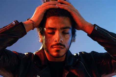 Portrait Of Fashion Man With Curly Hair On Blue Background