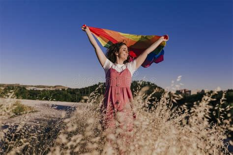 Woman Holding The Gay Rainbow Flag At Sunset Happiness Freedom And
