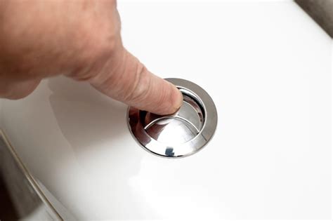 Premium Photo A Man Presses His Finger On The Flush Button In The