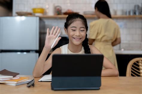 Premium Photo Smiling Little Asian Girl In Headphones Have Video Call