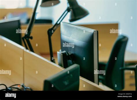 Modern Office Workspace Featuring A Sleek Monitor Twin Desk Lamps And