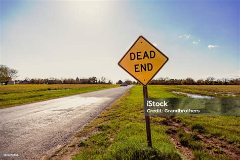 Dead End Road Sign With A Road Going To Horizon In The Background Stock