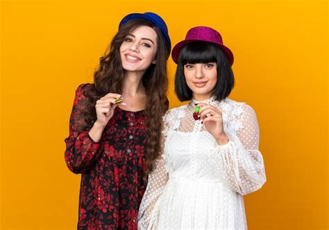Free Photo Two Pleased Party Girls Wearing Party Hat Both Holding