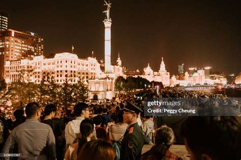 Cityscape Nightlife View Of A Busy Crowd Of People Around The Bund In