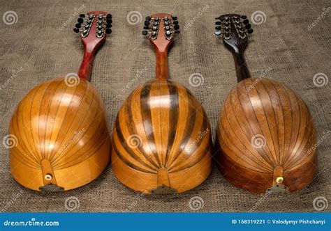 Three Old Mandolins On A Background Of Rough Burlap Texture Royalty