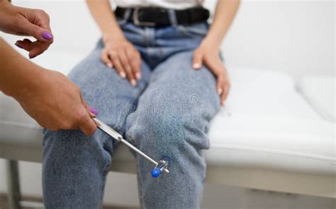 Neurologist Checks The Patient`s Reflexes By Hitting The Knee With A