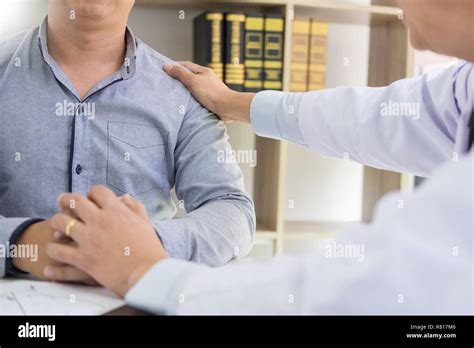 Patient Being Reassured Desperate Holding Hand By Doctor Encouraging