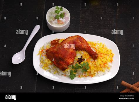 Chicken Biryani Tandoori Chicken Leg With Basmathi Rice And Raita Or
